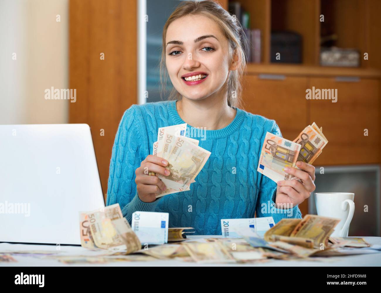 Happy young woman earning money being freelancer Stock Photo - Alamy
