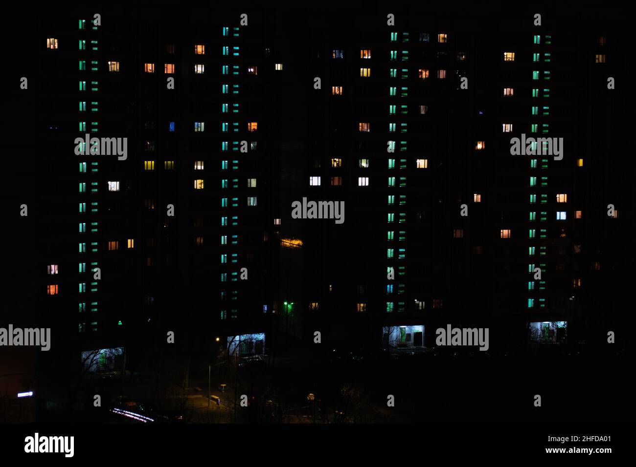 The dark night view on apartment building windows. City and urban night ...