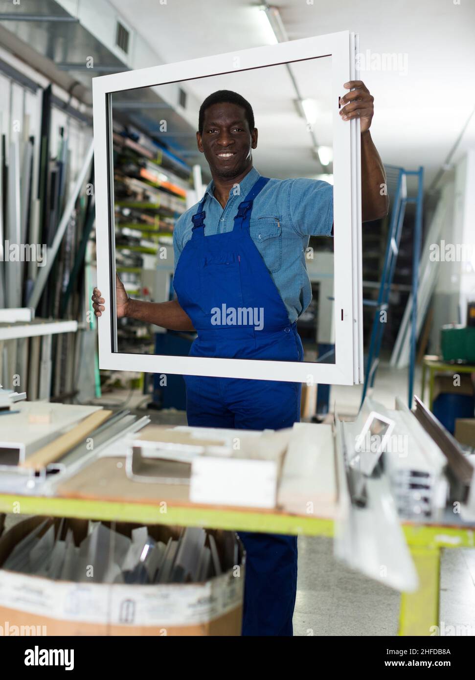 Portrait of man worker who is standing with window frame Stock Photo ...