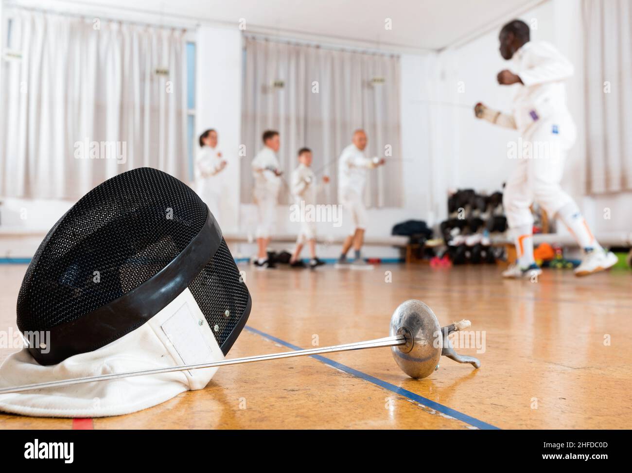 Closeup of fencing mask and rapier on floor in gym Stock Photo - Alamy