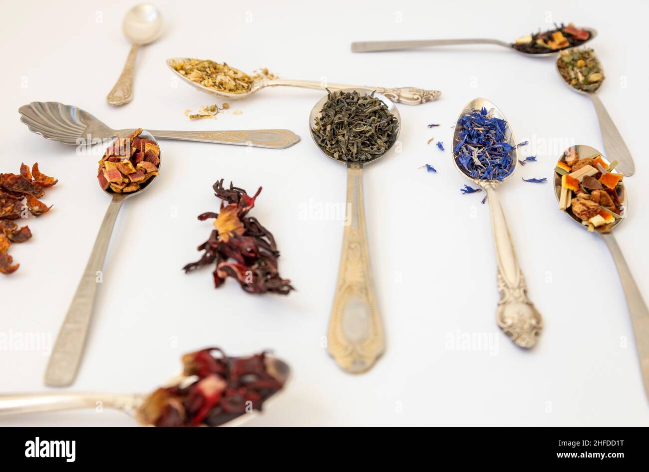 Nine spoons of different types of tea, laid out in random order, real ...