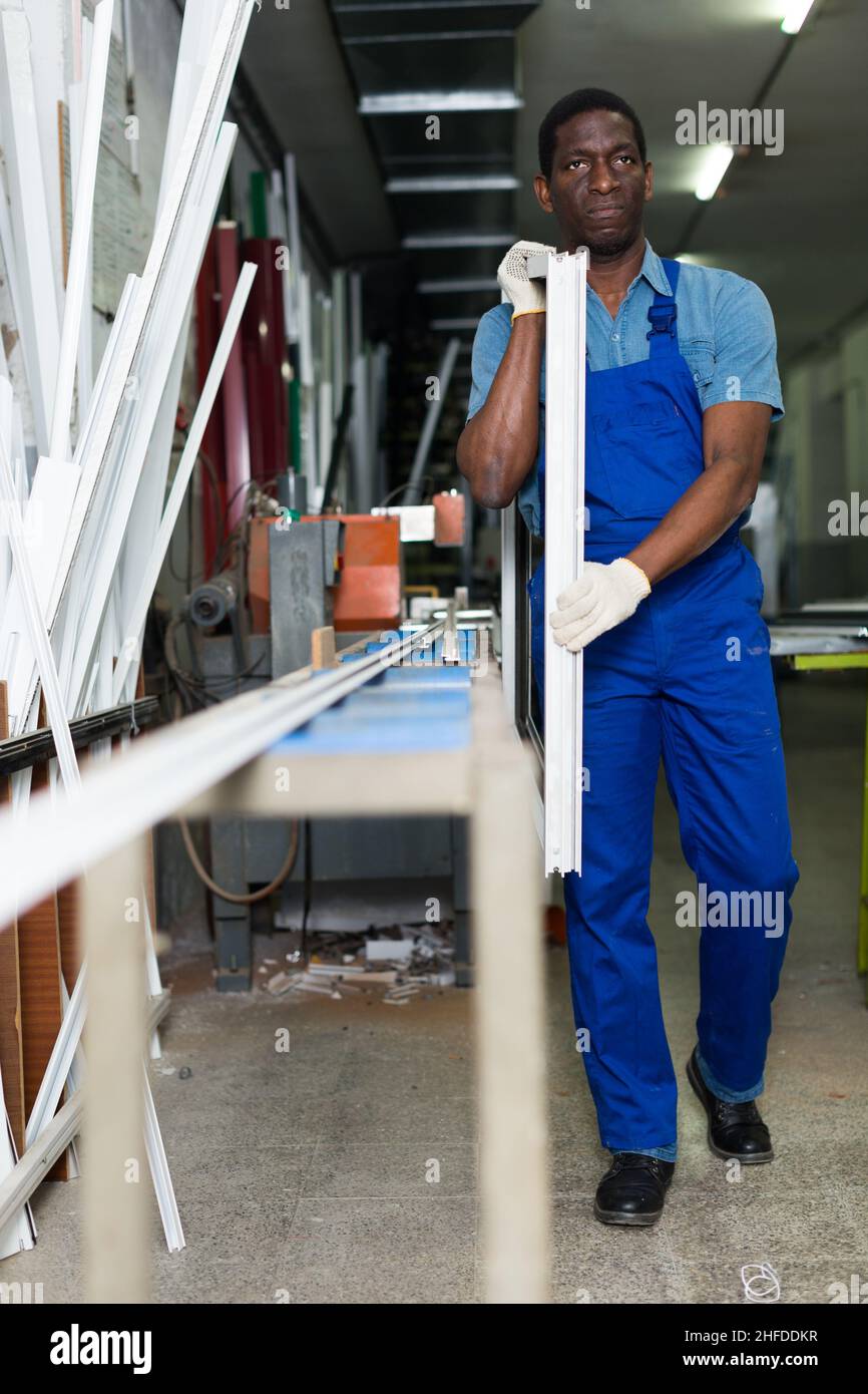 Male master is working with window frame Stock Photo - Alamy