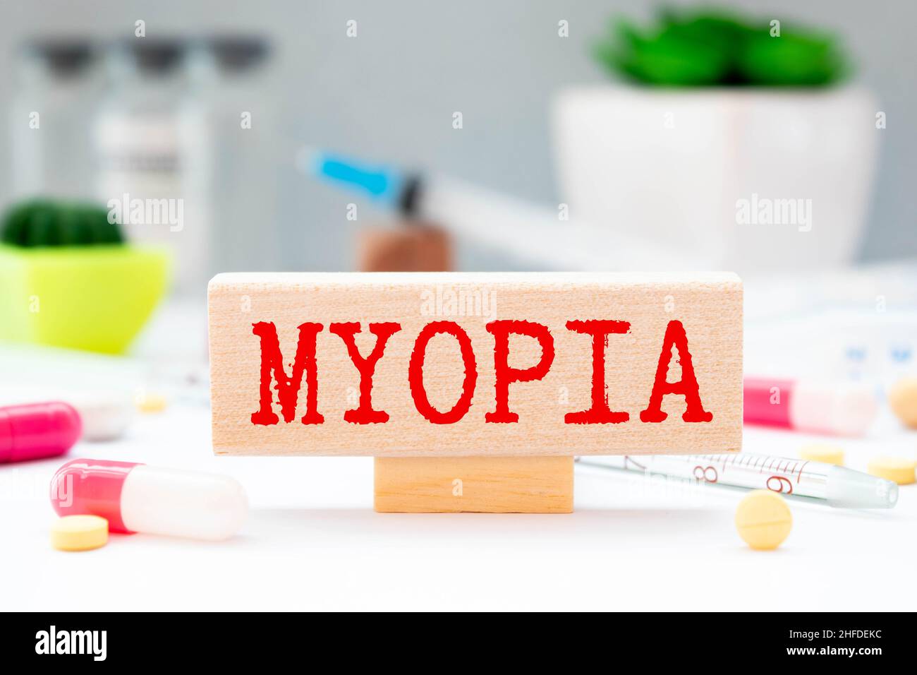 top view blocks with word MYOPIA on the white background with pills ...