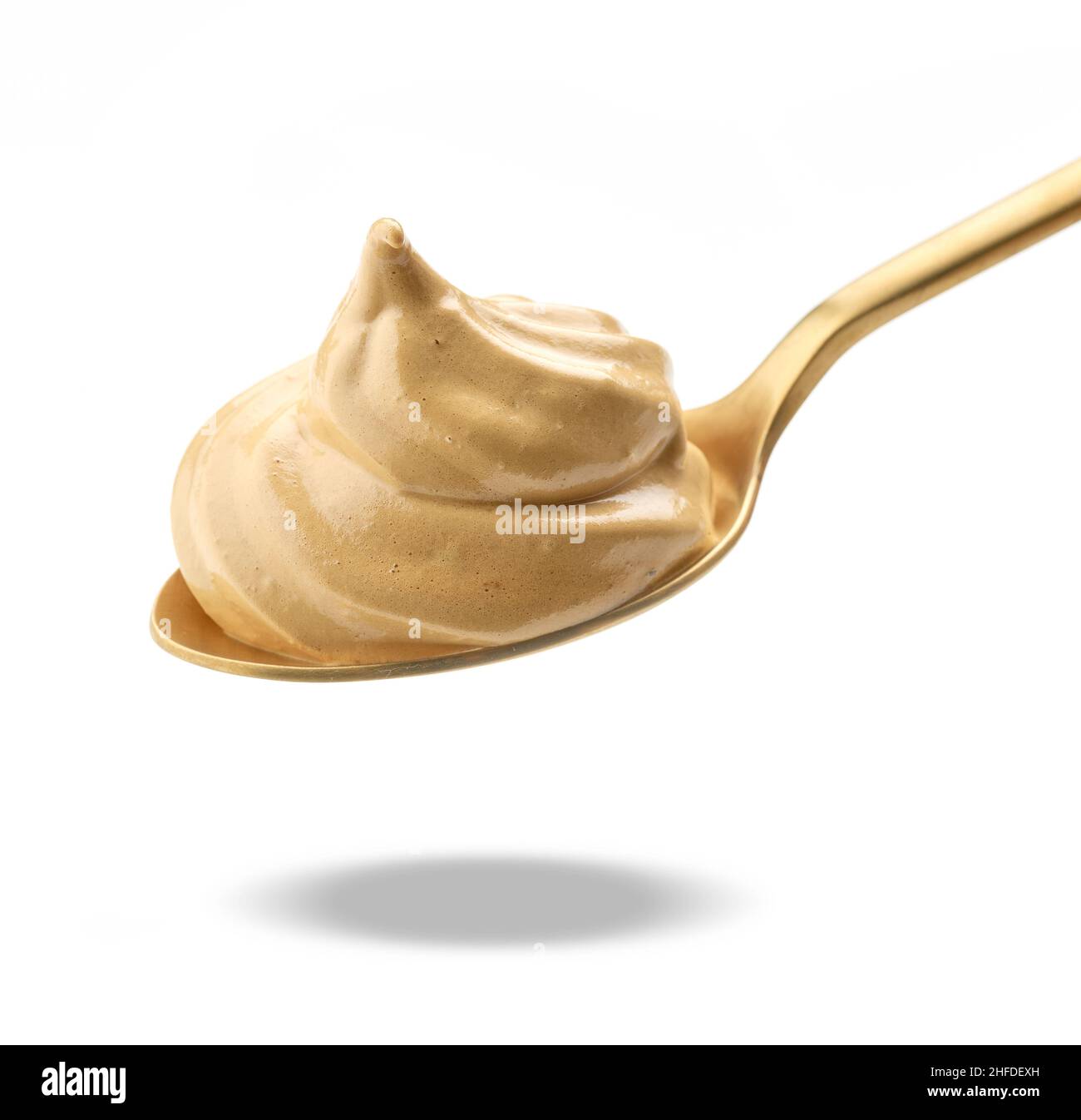 spoon of whipped caramel and coffee mousse dessert isolated on white ...