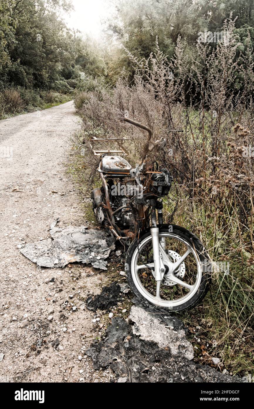 Stolen, burned out and abandoned motorcycle in the countryside Stock ...
