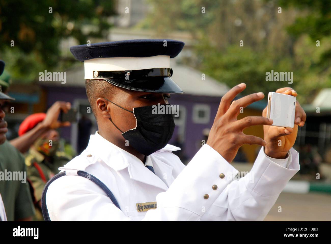 Lagos, Nigeria. 15th Jan, 2022. Military man takes photo with phone the parade and laying of ...