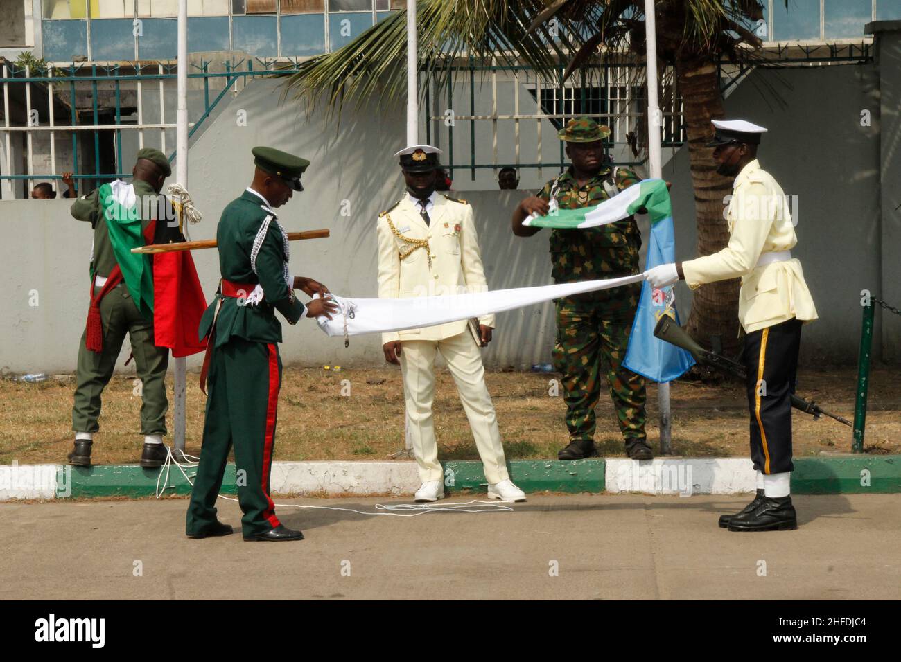 Lagos, Nigeria. 15th Jan, 2022. Military men folding military and Nigeria flags after the parade ...