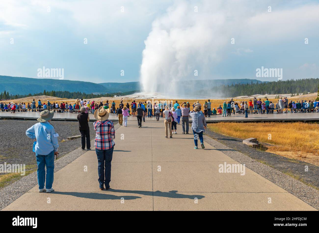 People looking at the Old Faithful geothermal volcanic hot spot during ...