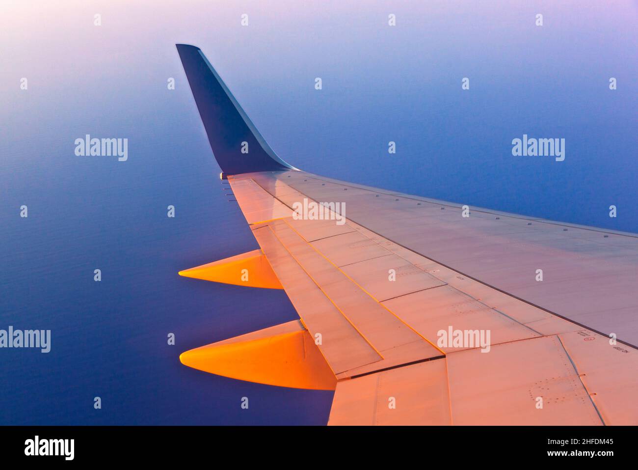 wing of aircraft in sunset Stock Photo - Alamy