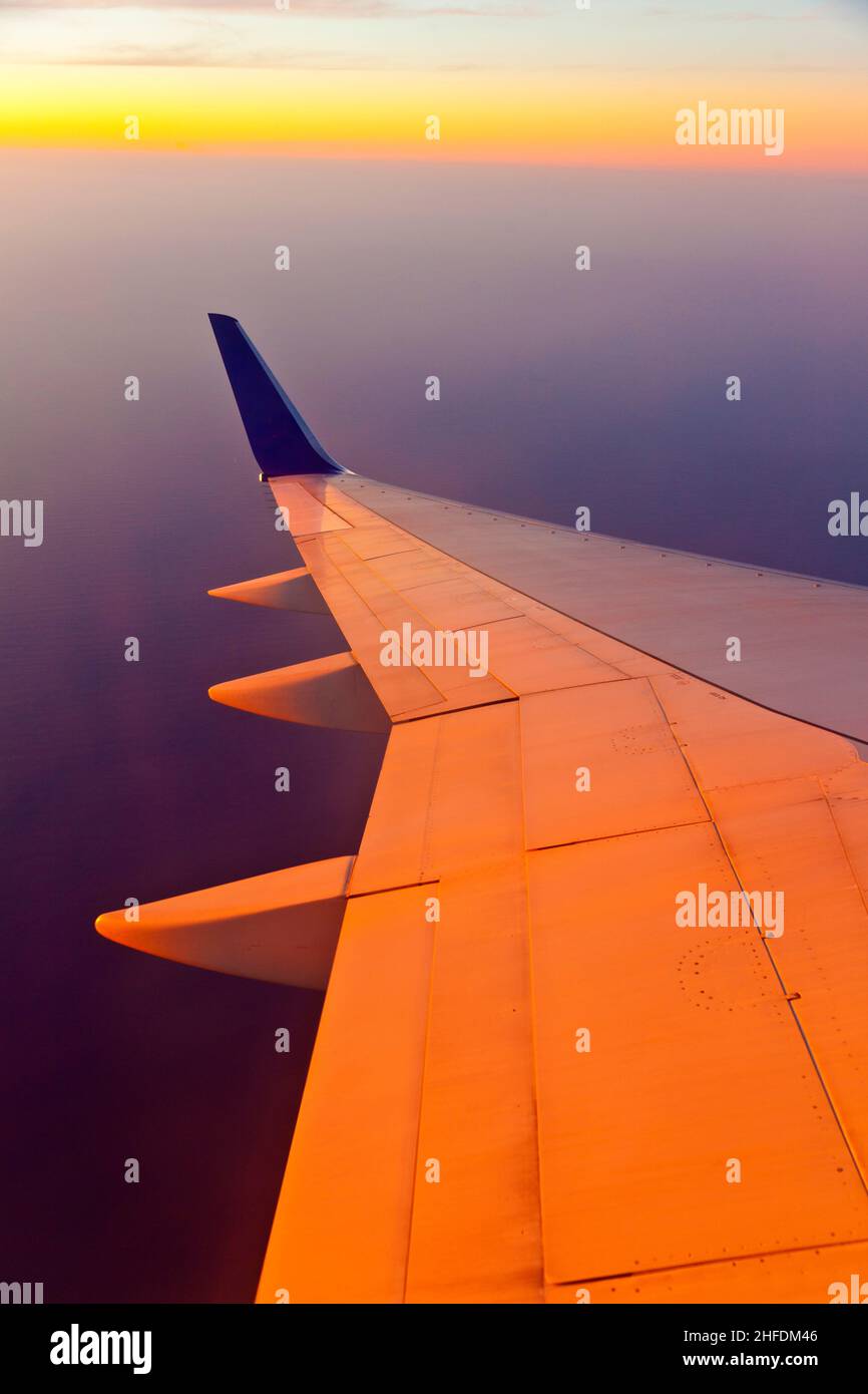 wing of aircraft in sunset Stock Photo - Alamy