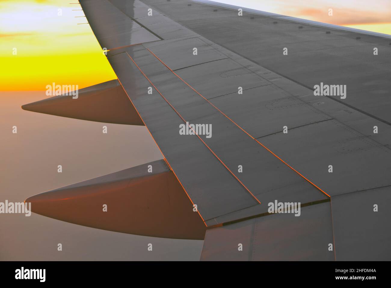 wing of passenger aircraft in spectacular sunset Stock Photo - Alamy