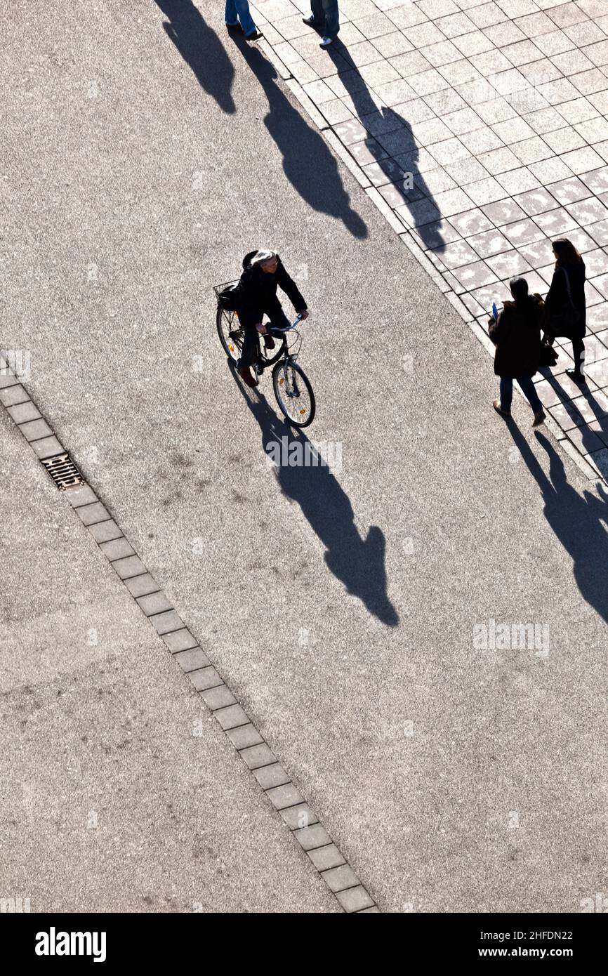 people walking at the street with long shadows Stock Photo - Alamy