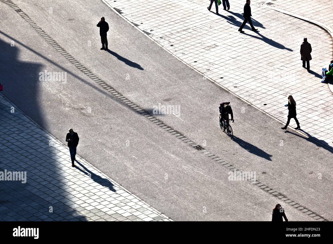 people walking at the street with long shadows Stock Photo - Alamy