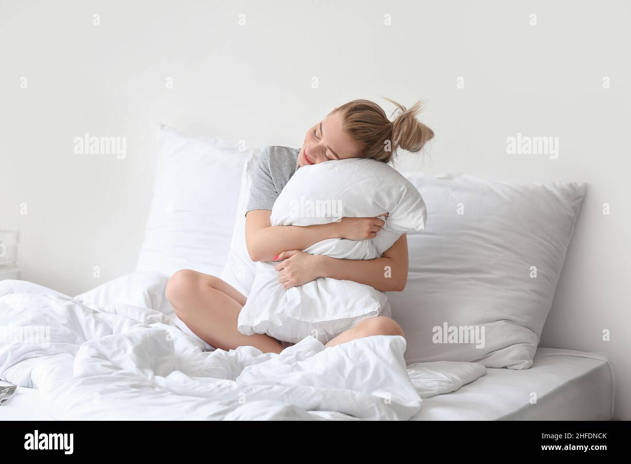 Beautiful woman hugging pillow hi-res stock photography and images - Alamy