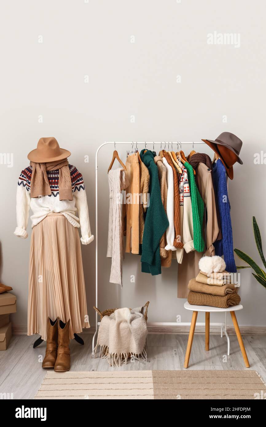 Interior of dressing room with mannequin, rack and warm sweaters Stock ...