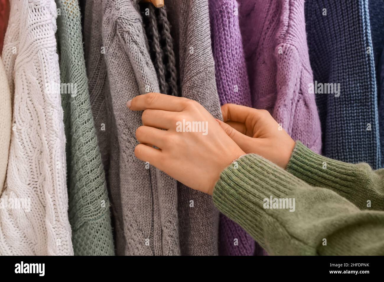 Woman near rack hanging hi-res stock photography and images - Alamy