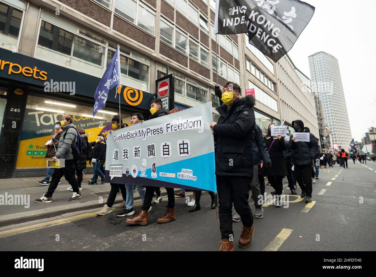 London, UK. 15th Jan, 2022. Protesters march with a banner, saying ...