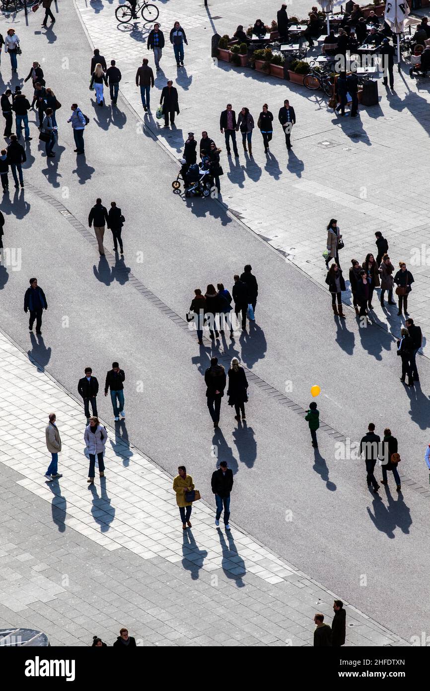 people walking at the street with long shadows Stock Photo - Alamy