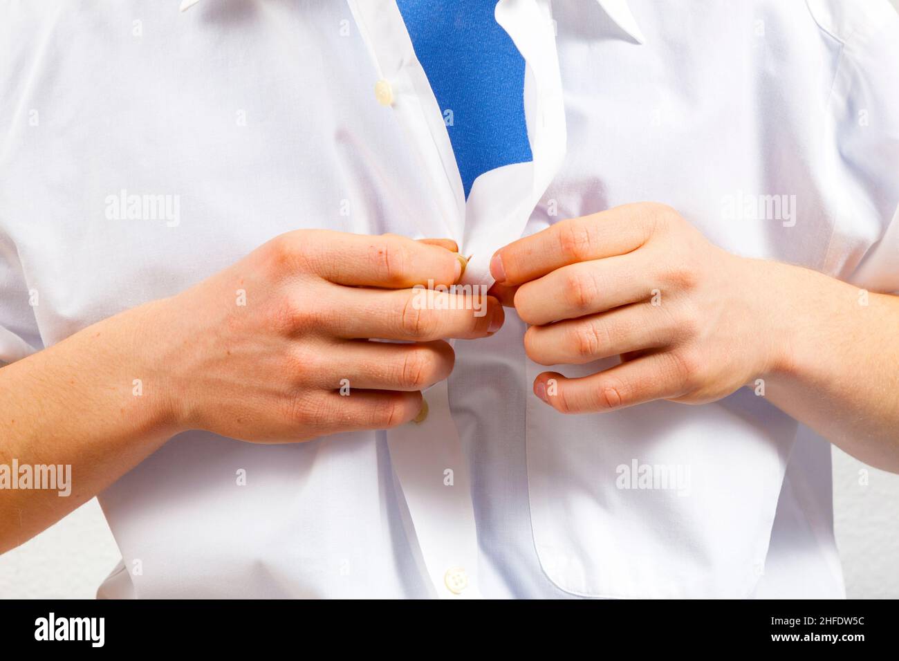 buttoning a fresh, white shirt, on plain white background Stock Photo ...