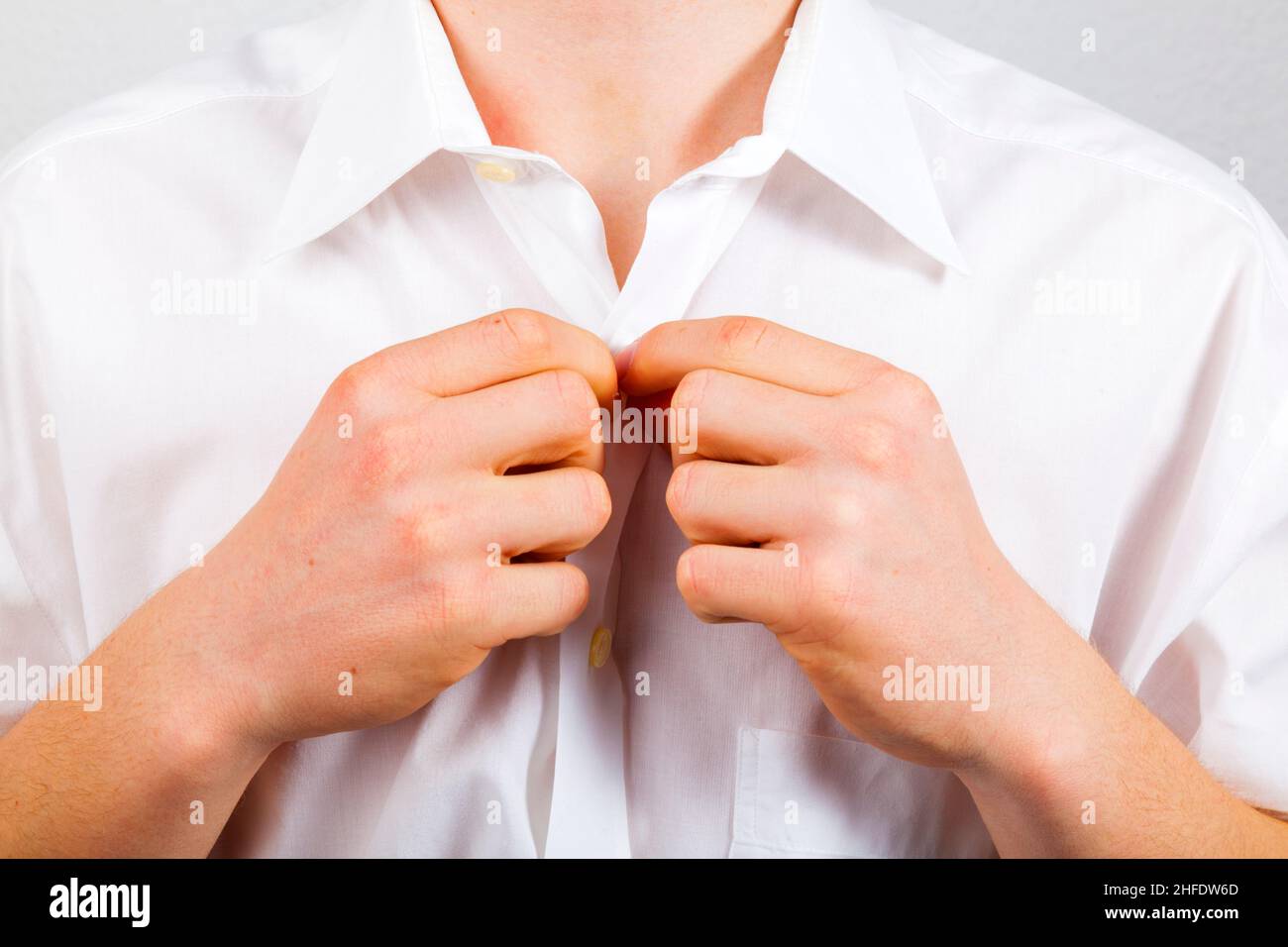 buttoning a fresh, white shirt, on plain white background Stock Photo ...
