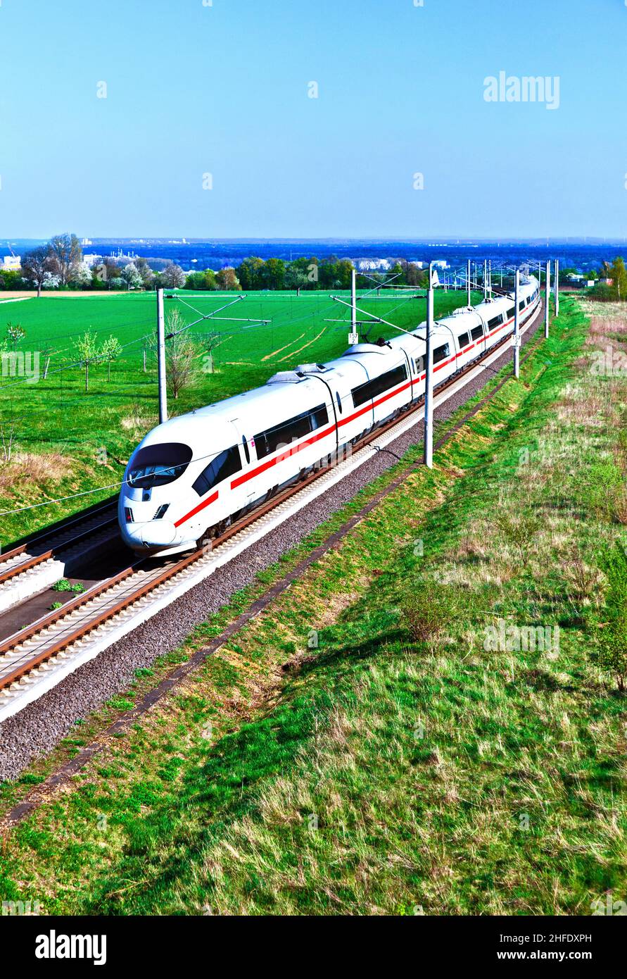 high speed train with full speed in landscape Stock Photo - Alamy