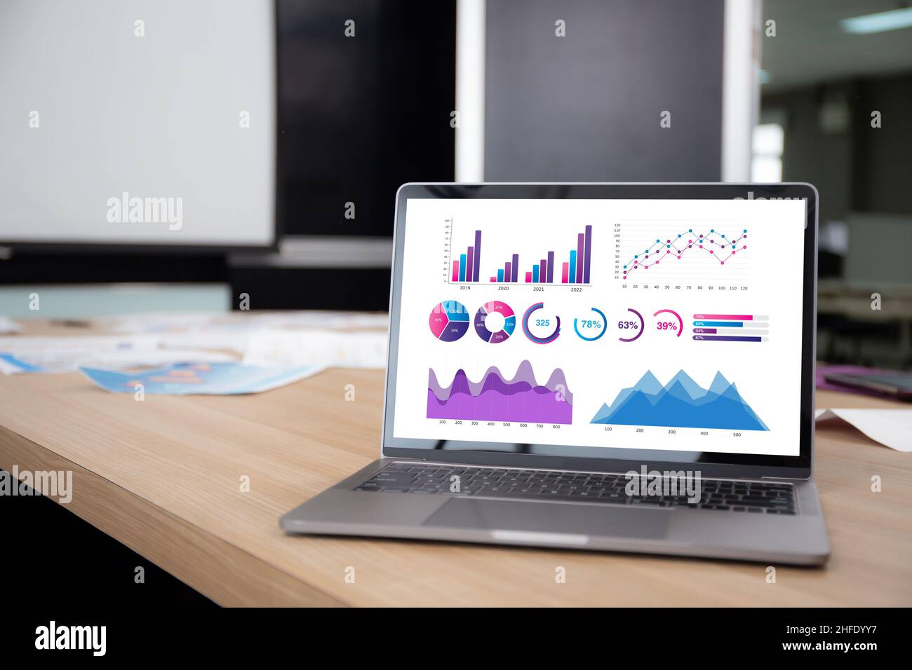 Display monitor of laptop computer with graph chart of investment and ...