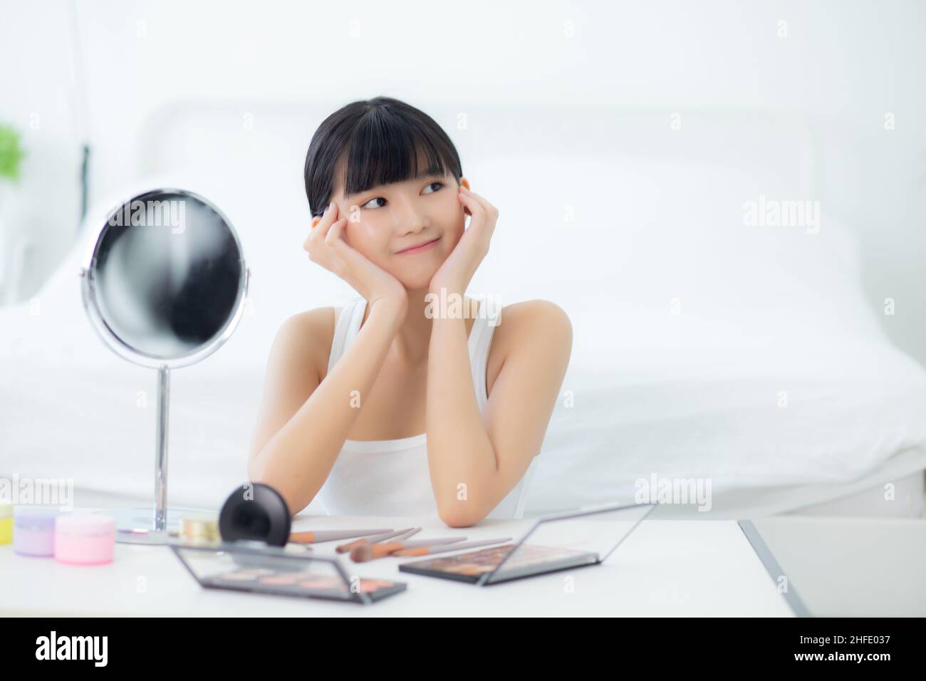 Beautiful face of young asian woman with happy smiling and touch cheek ...