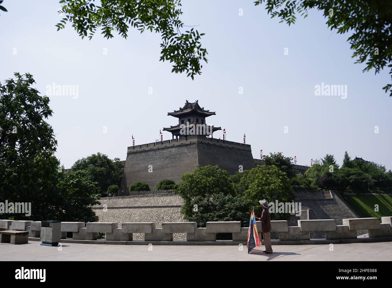 A citizen is ready to fly a kite under the ancient gate tower in Xi'an ...
