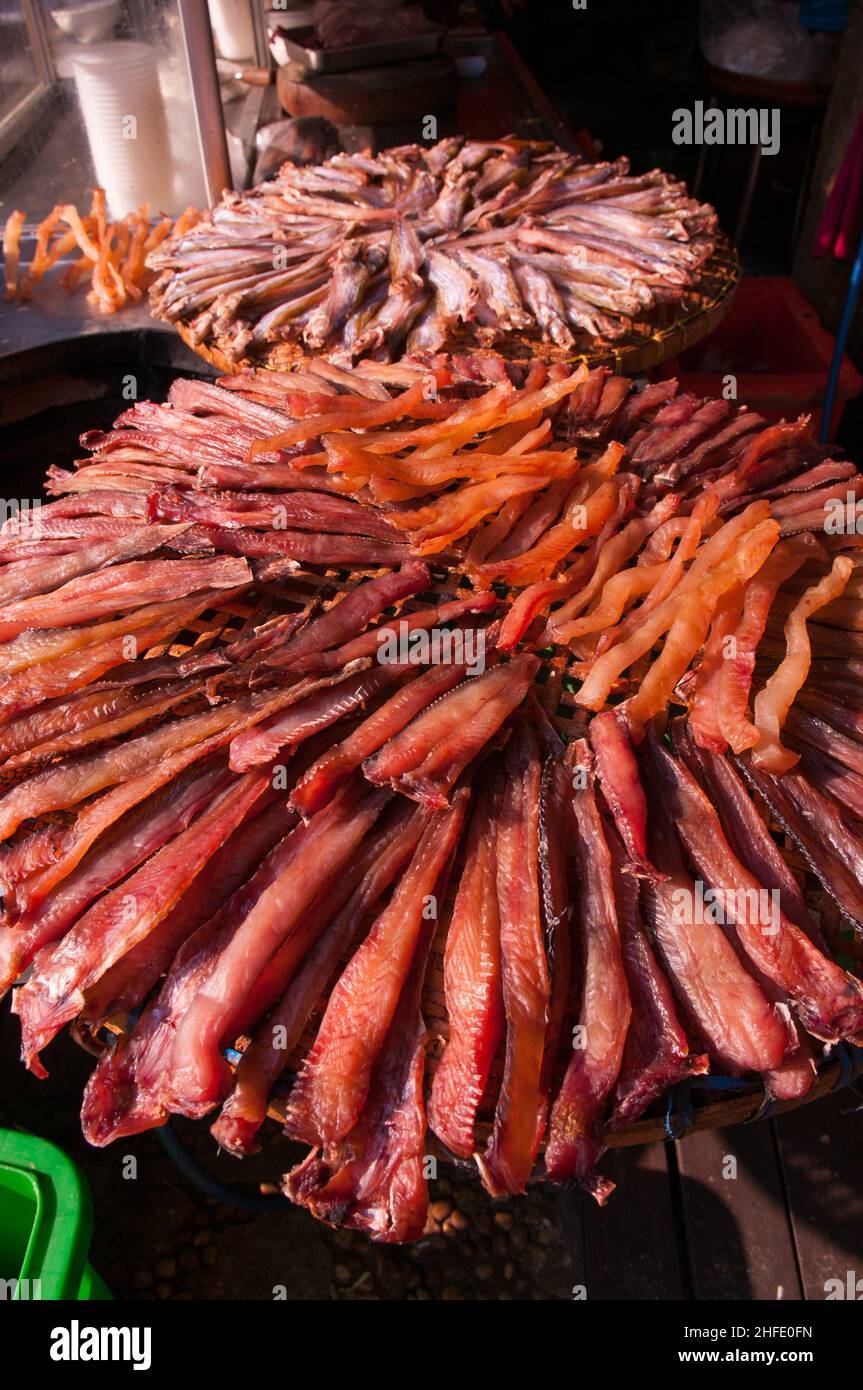 fish drying in the sun at a local restaurant during Chinese New Year ...