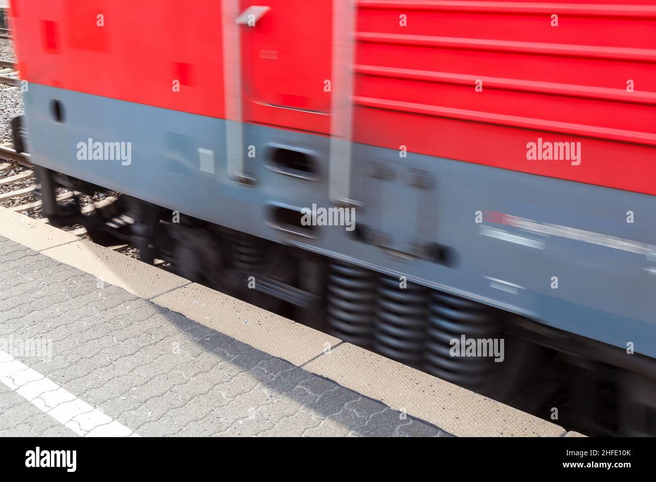 red train passes with speed Stock Photo - Alamy