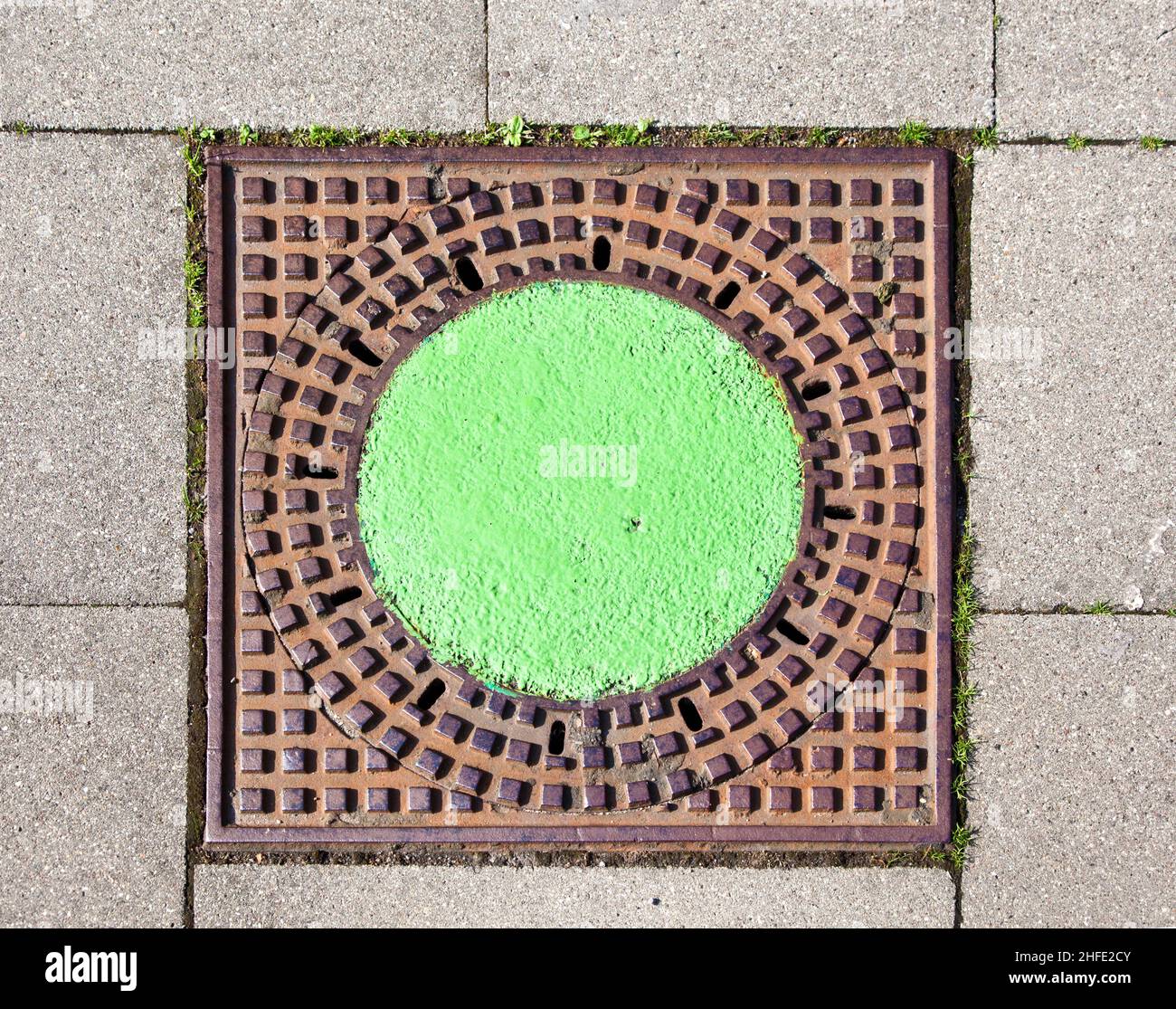 A manhole cover in the street to enter the canalisation Stock Photo - Alamy
