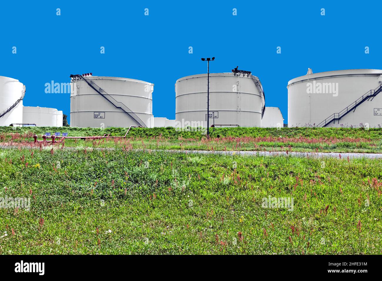 Big white industrial tank with blue sky Stock Photo - Alamy