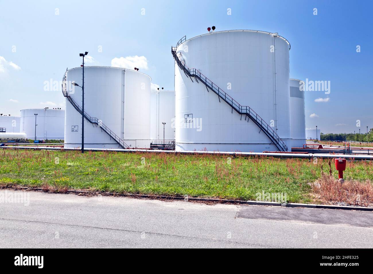 Big white industrial tank with blue sky Stock Photo - Alamy