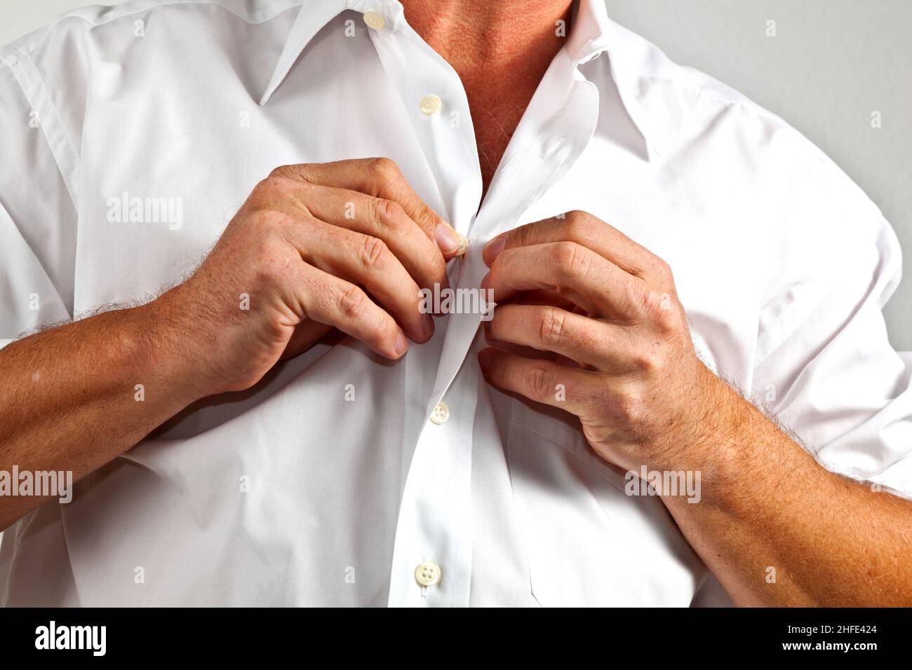 man closing his shirt Stock Photo - Alamy