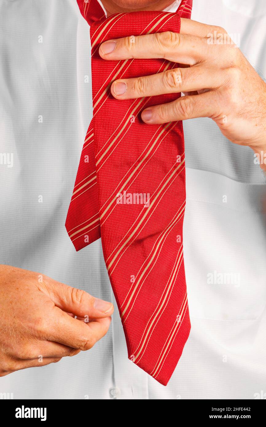 attractive man binding his tie Stock Photo - Alamy