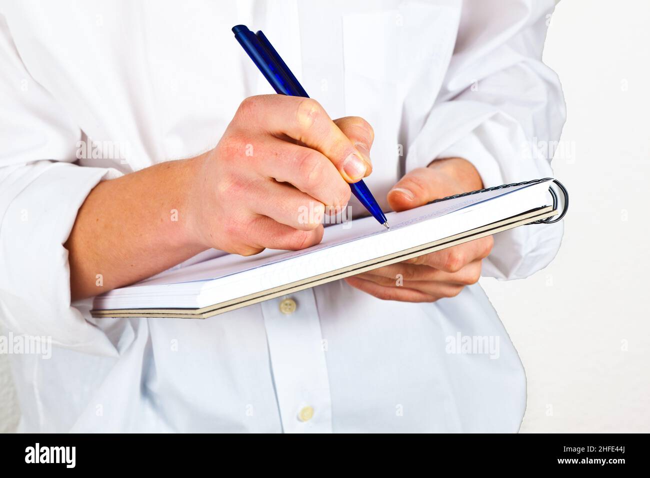 man writing in a book Stock Photo - Alamy