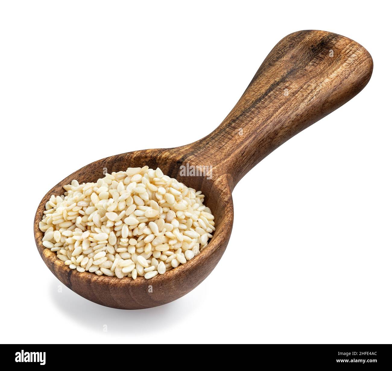 white sesame seeds in wooden spoon isolated Stock Photo - Alamy