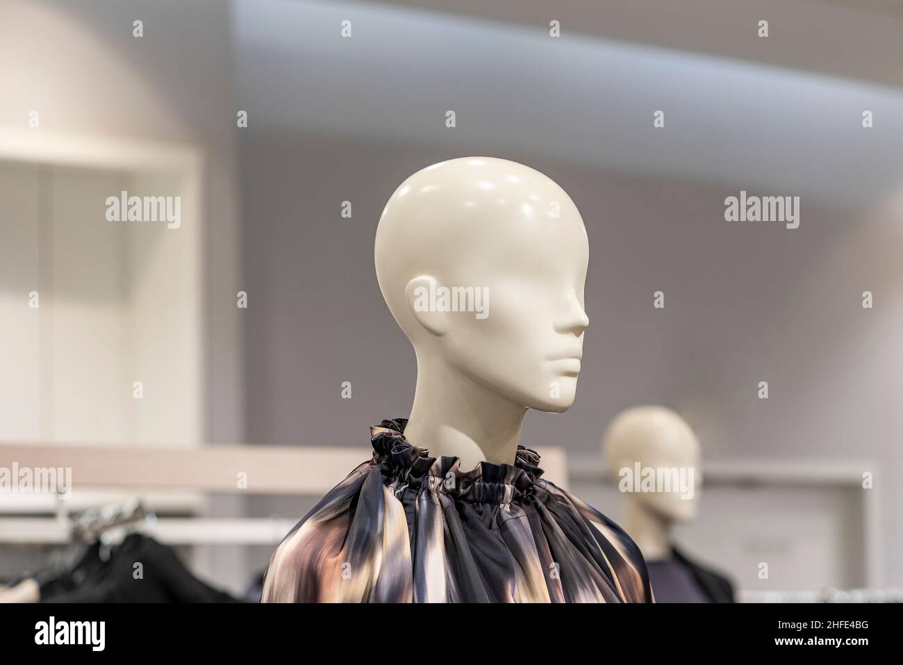 front image of shiny white female mannequin doll with a male mannequin ...