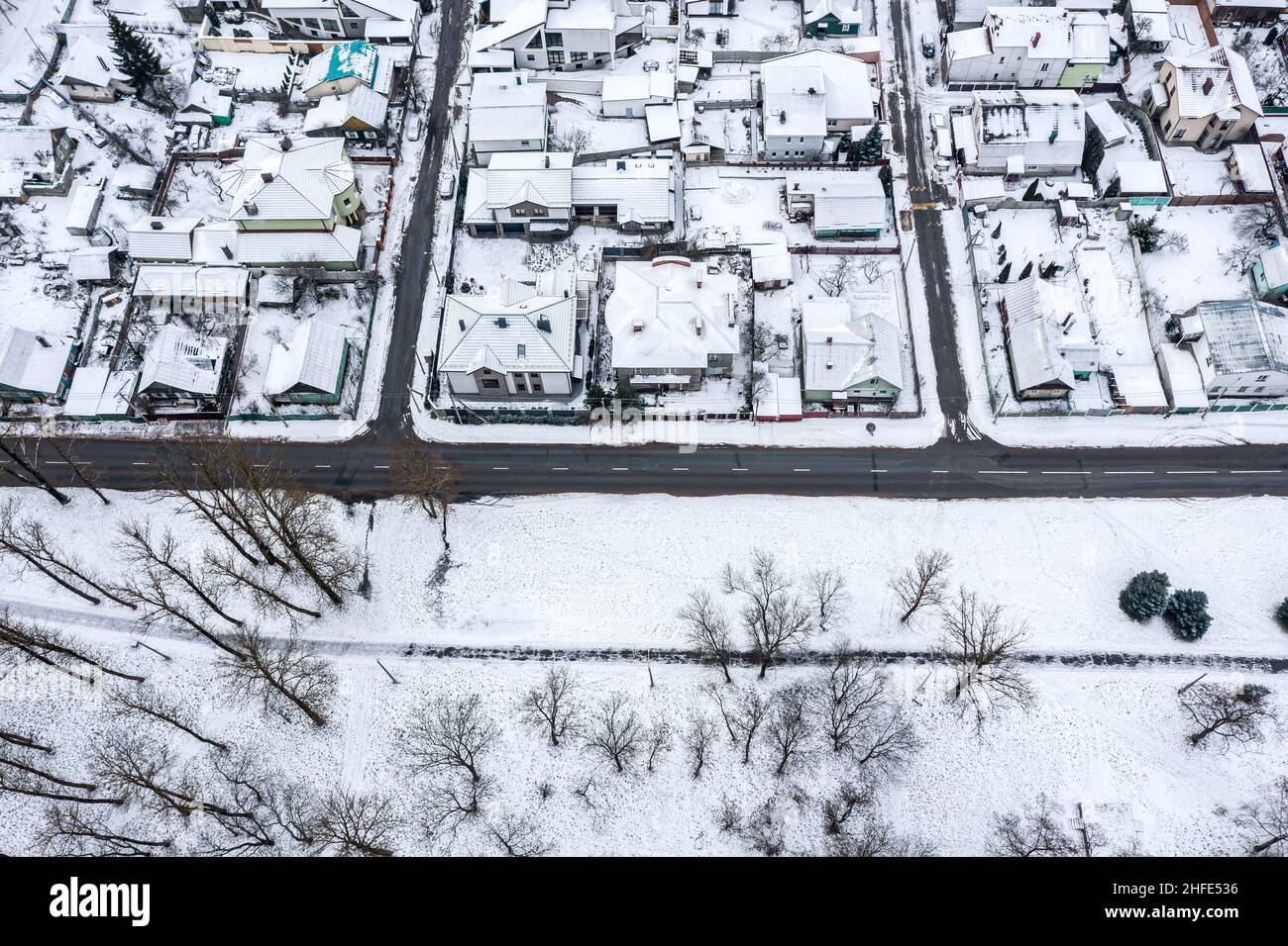 aerial view of residential houses covered snow with snow on covered ...