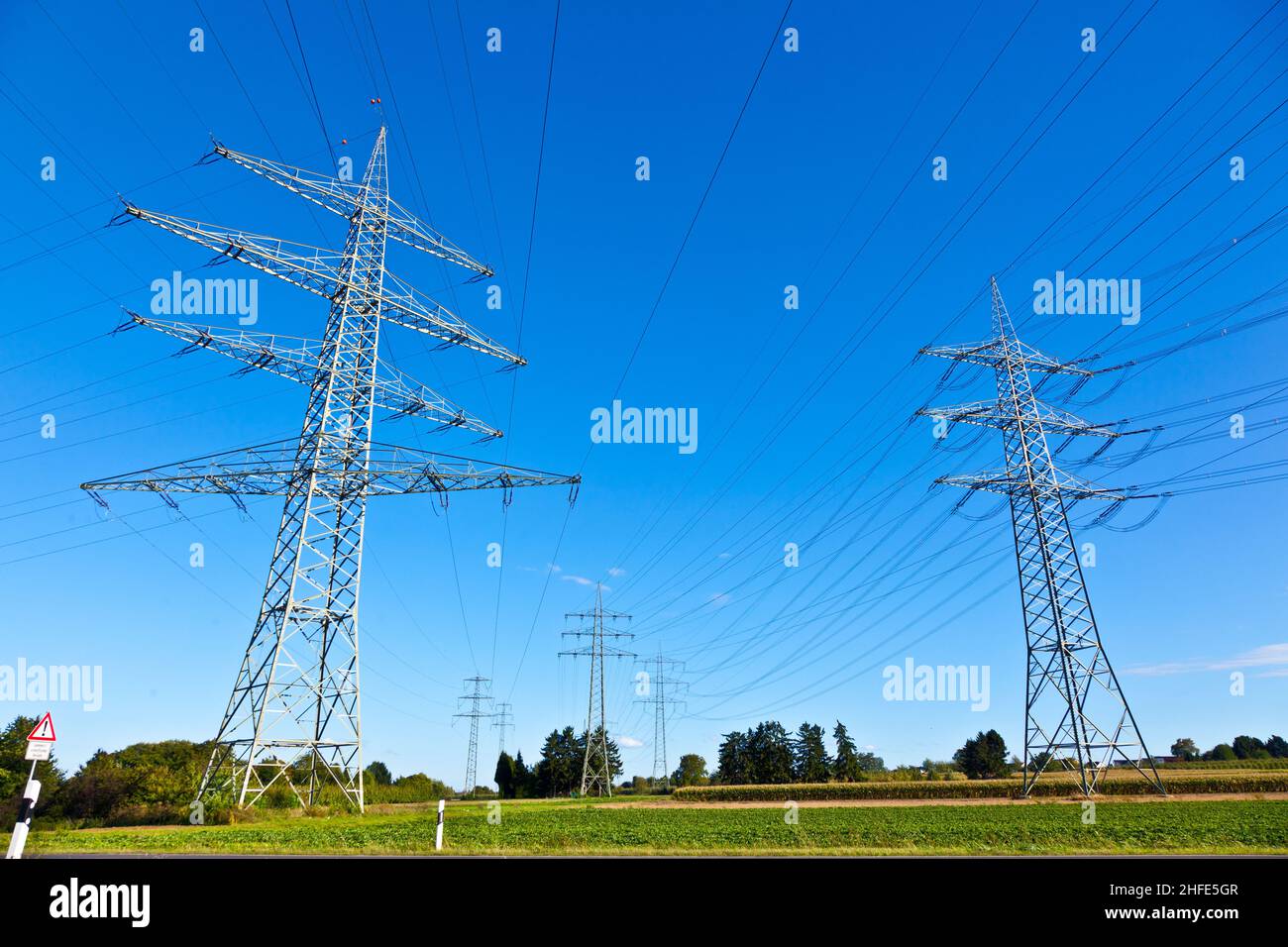 Steel electricity pylon on bright blue sky Stock Photo - Alamy