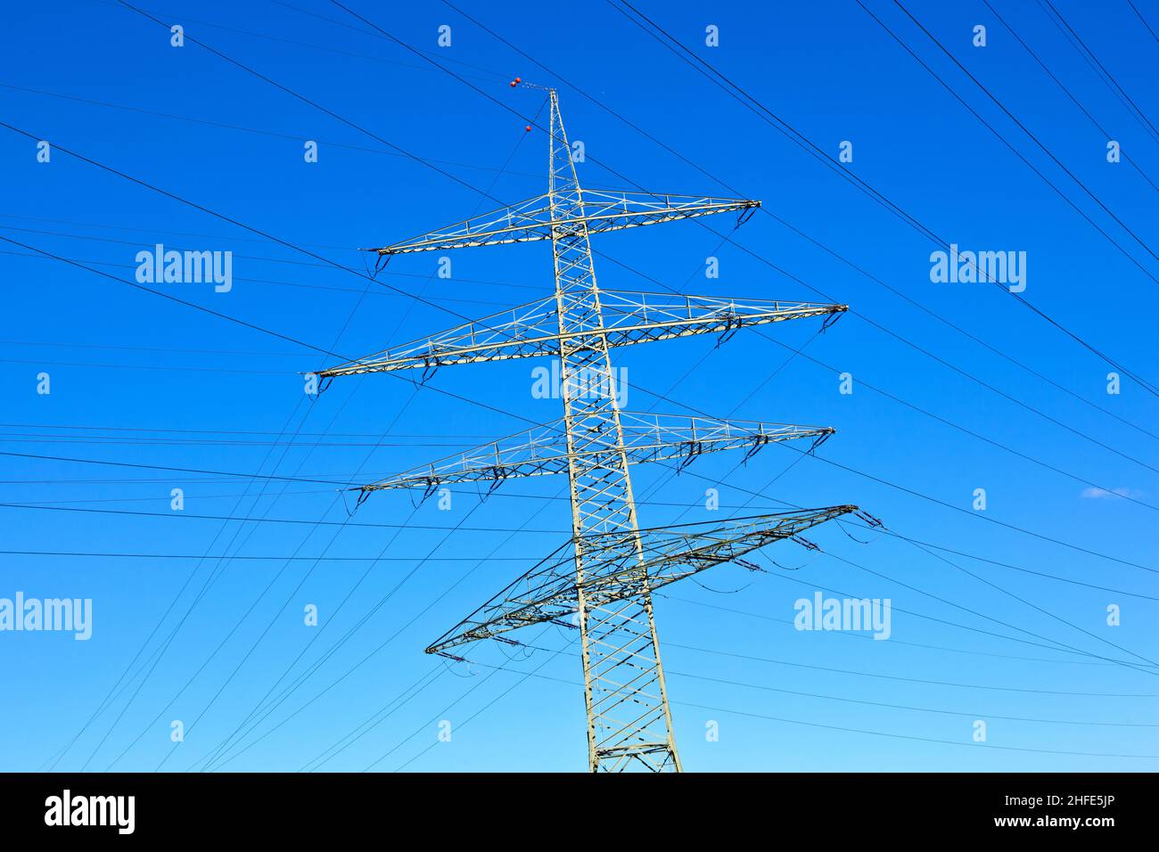 Steel electricity pylon on bright blue sky Stock Photo - Alamy