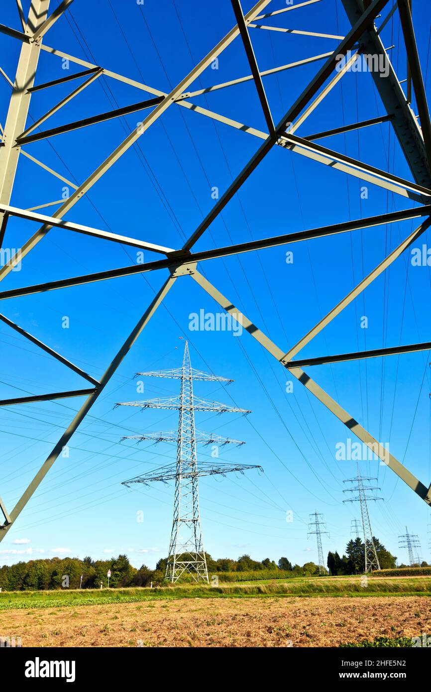 Steel electricity pylon on bright blue sky Stock Photo - Alamy