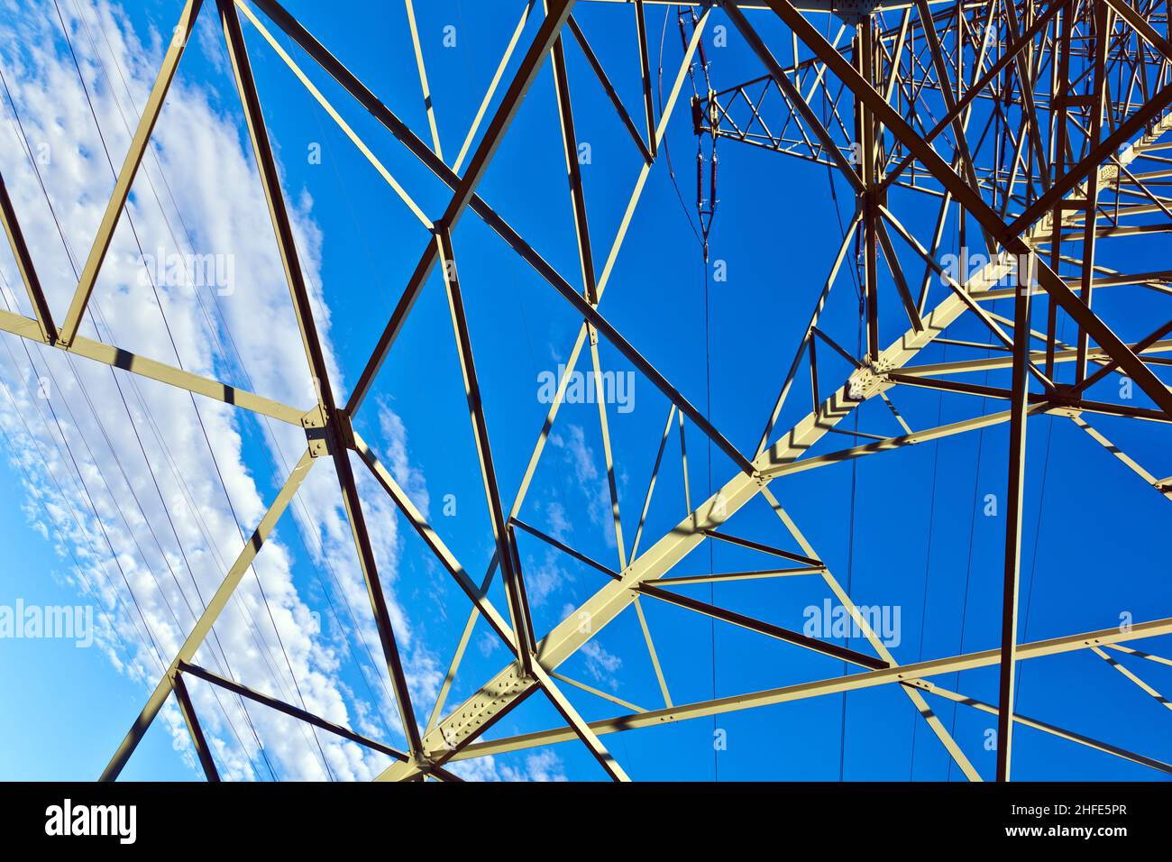 electrical pylon under blue sky, power line cable Stock Photo - Alamy