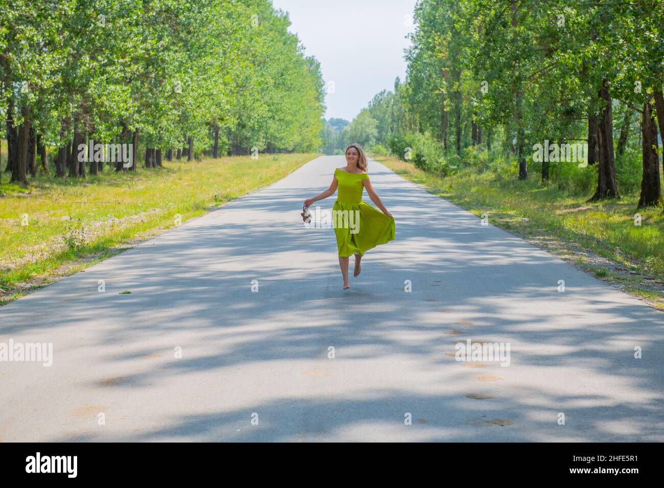 one happy girl running on the road Stock Photo - Alamy