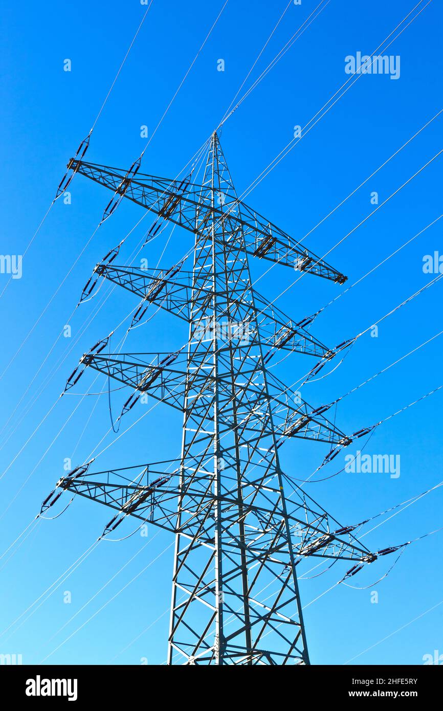 Steel electricity pylon on bright blue sky Stock Photo - Alamy