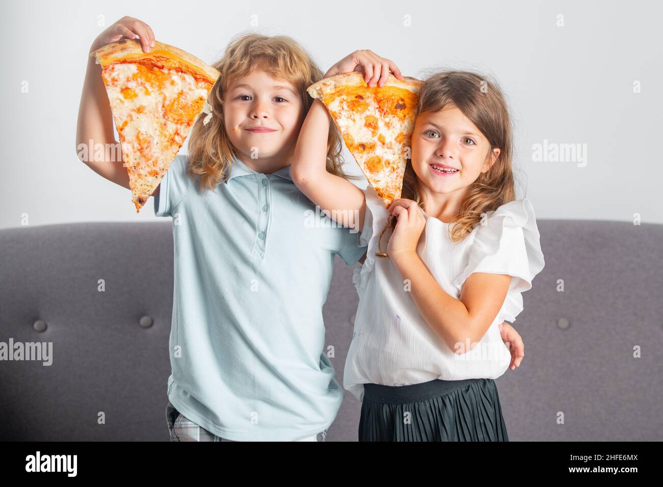Pizza and kids, slices pizza in kids hand. Children eating tasty fast ...