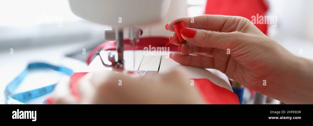 Hands woman seamstress sewing red hi-res stock photography and images ...