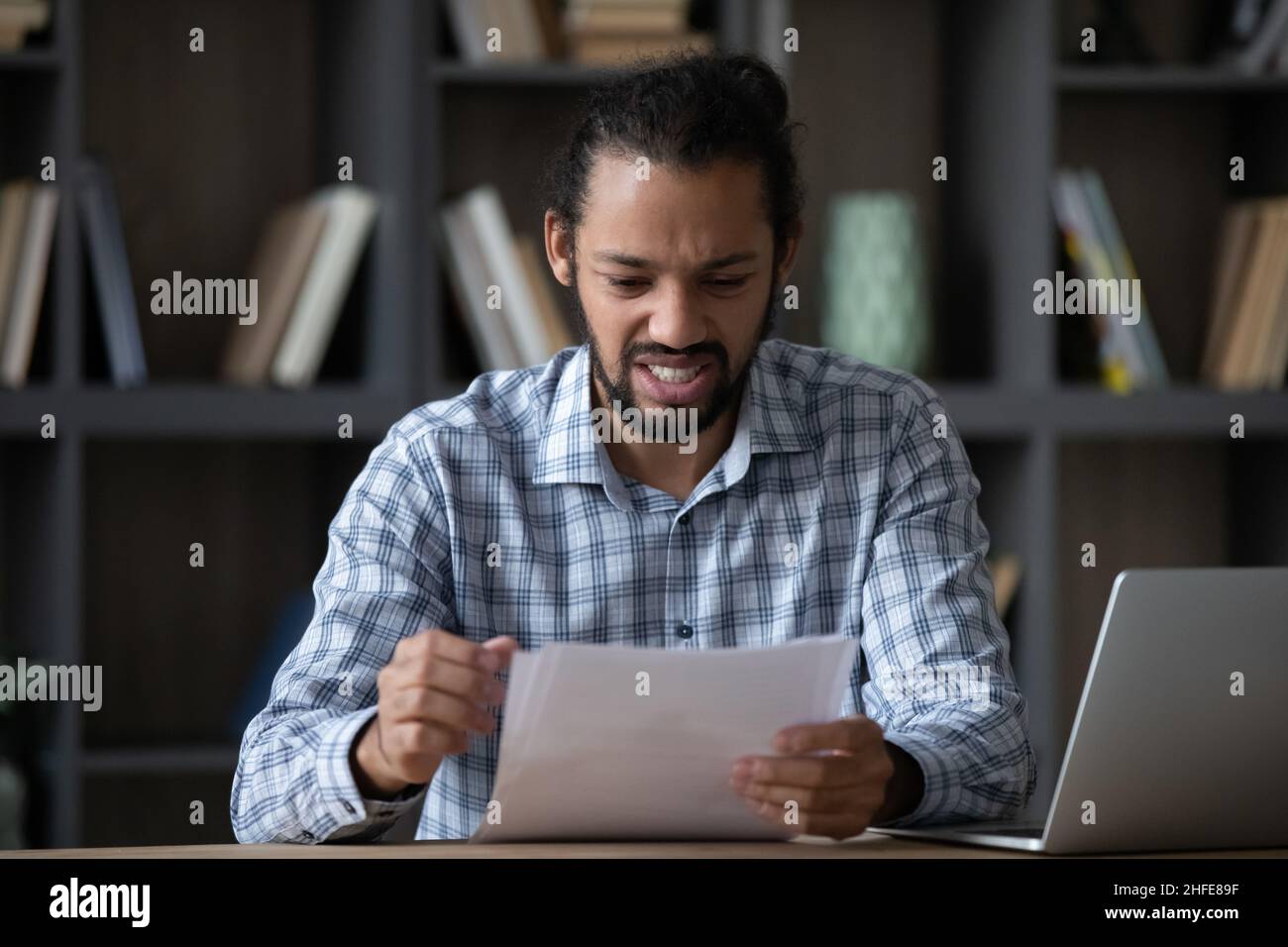 Upset man reading bad news hi-res stock photography and images - Alamy