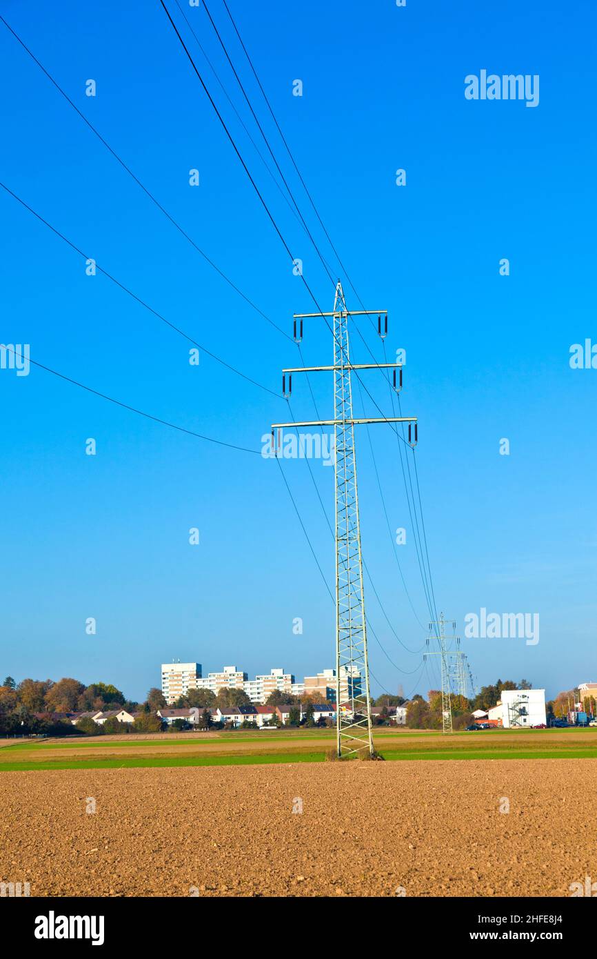 electrical tower in field under blue sky Stock Photo - Alamy