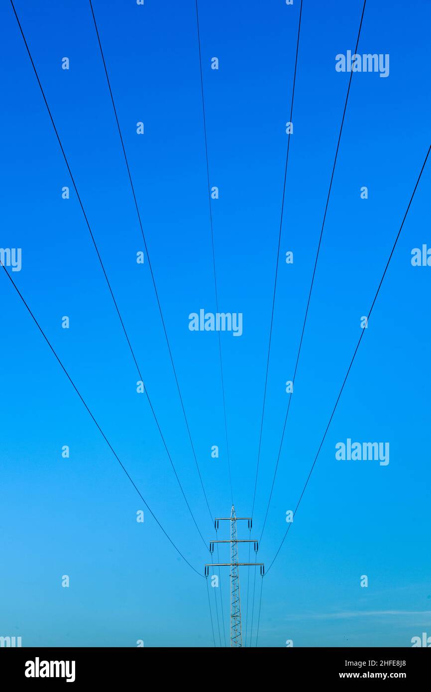 electrical tower in field under blue sky Stock Photo - Alamy